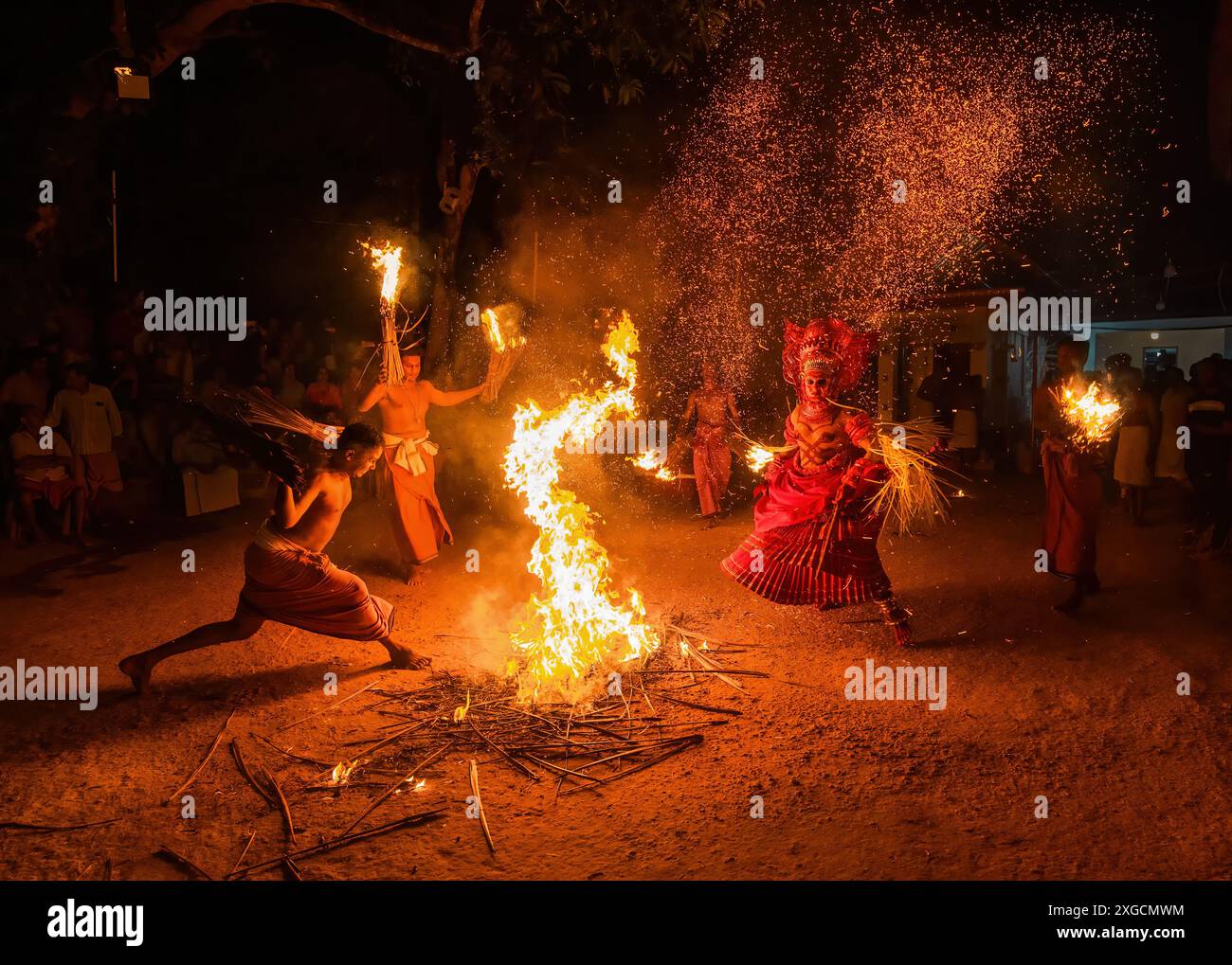 This image depicts a traditional Kandanar KelanTheyyam performance ...