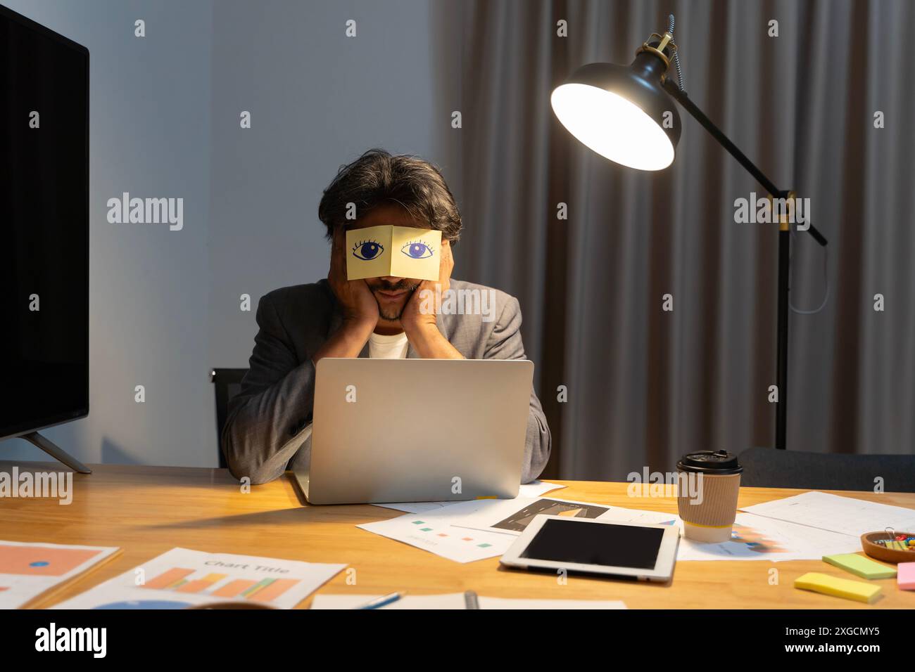 Exhausted young Caucasian man worker have sticker pads on eyes sleeping ...