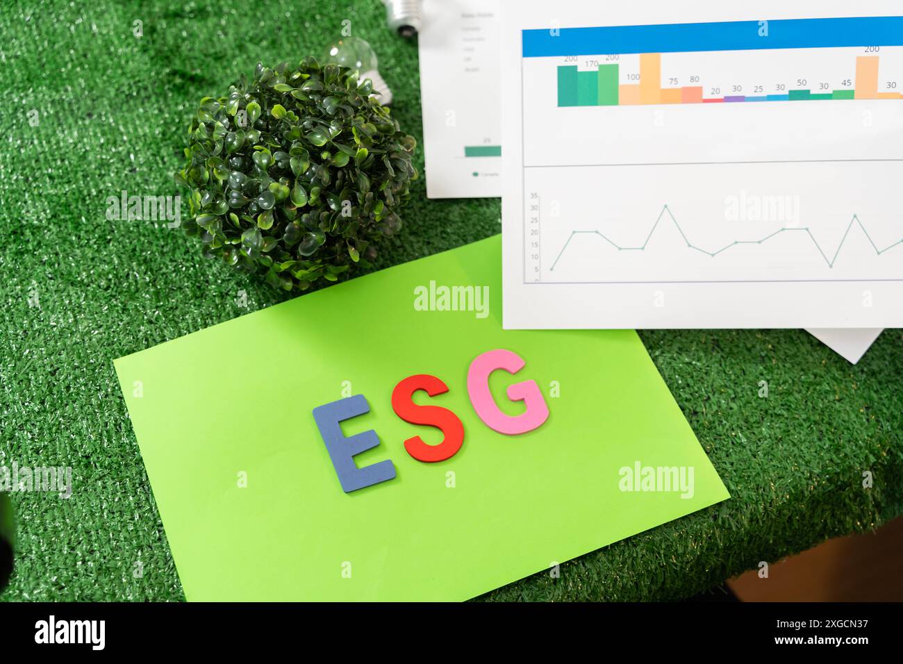 Green paper with the word "ESG" written on it. The paper is green and ...