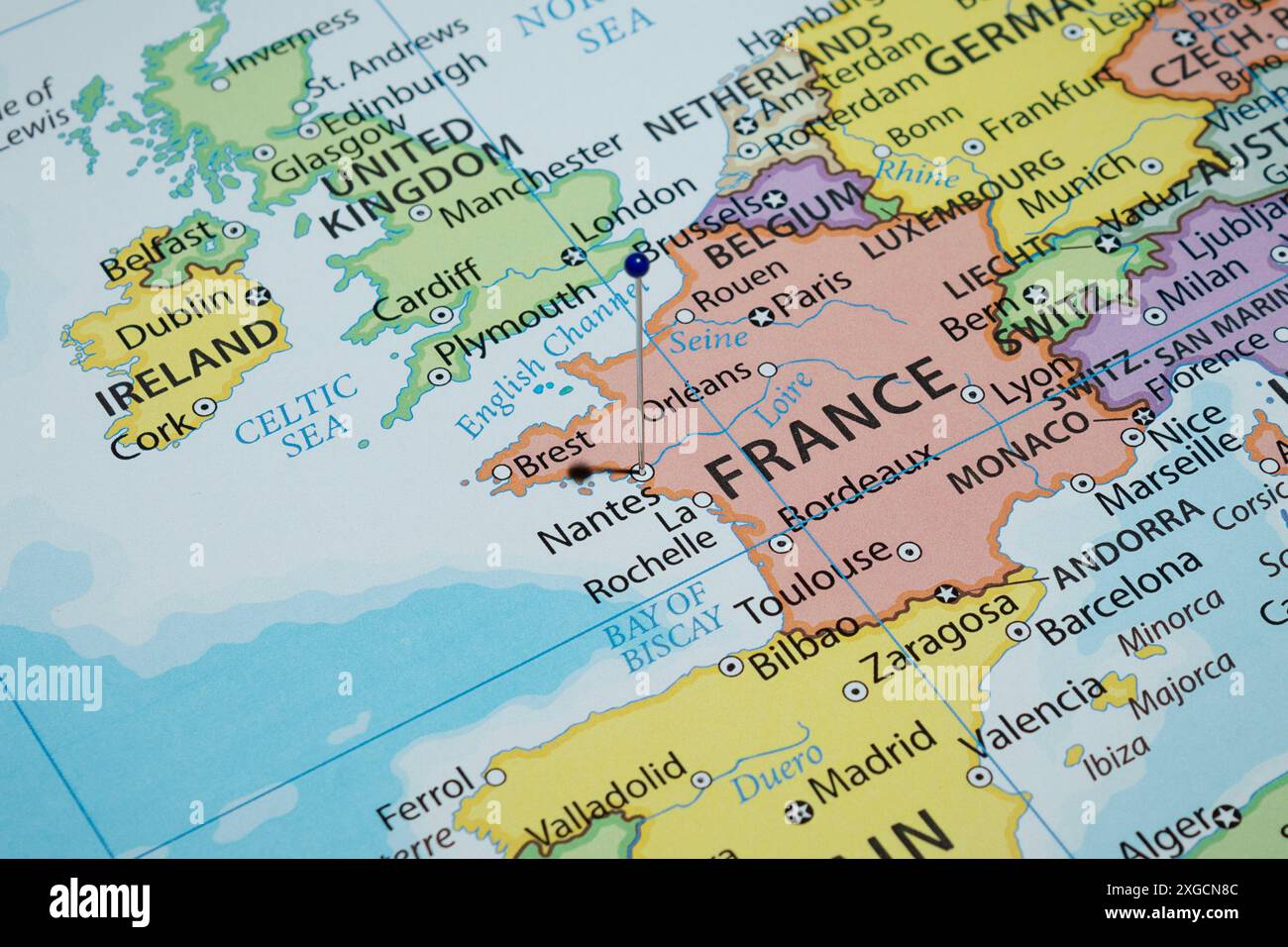 Close up to a Nantes city with a blue pin needle into France country ...