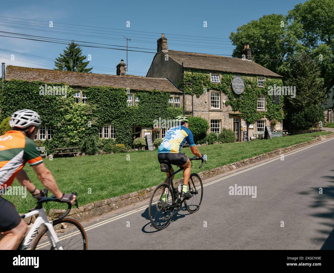 The Lister Arms and cyclists in Malham village in the Yorkshire Dales ...