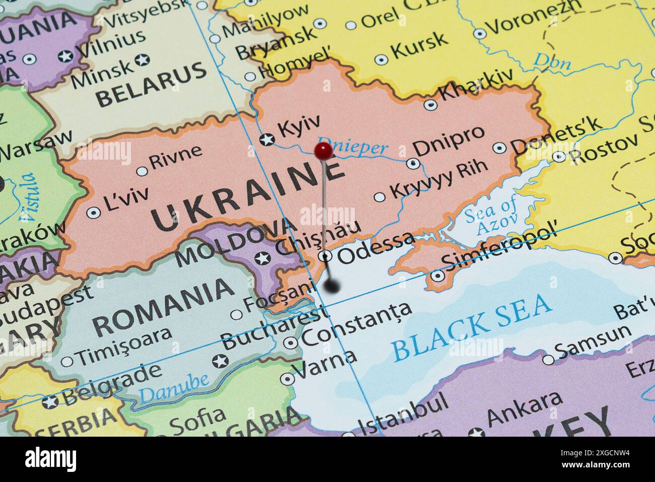 Close up to a Odessa city with a red pin needle into Ukraine country ...