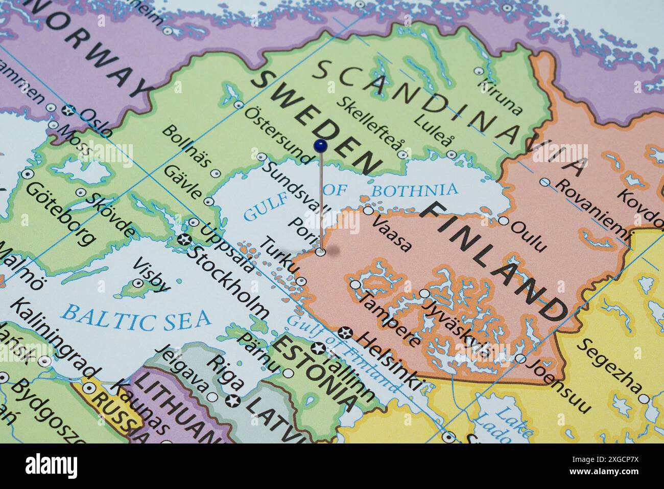 Close up to a Pori city with a blue pin needle into Finland country ...