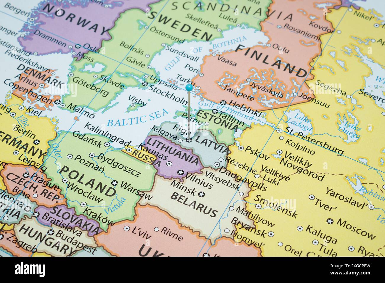 Close up to a Riga city with a light blue pin needle into Latvia ...