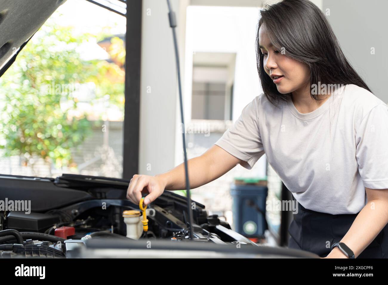 Asian driver woman checking car radiator problems, female checks break down vehicle engine ...