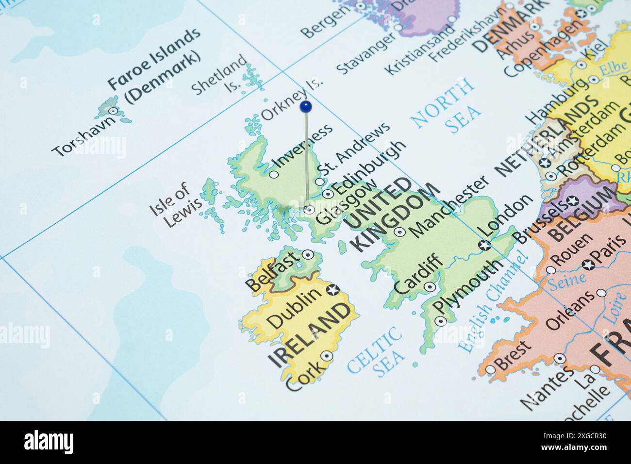 Close up to a Glasgow city with a blue pin needle into Scotland country ...