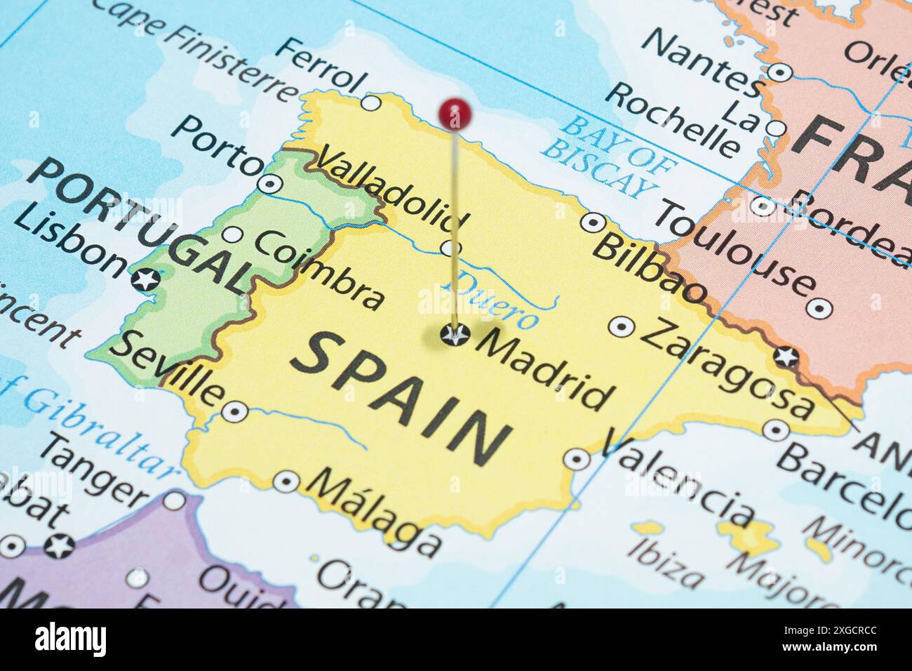Close up to a Madrid city with a red pin needle into spain country ...