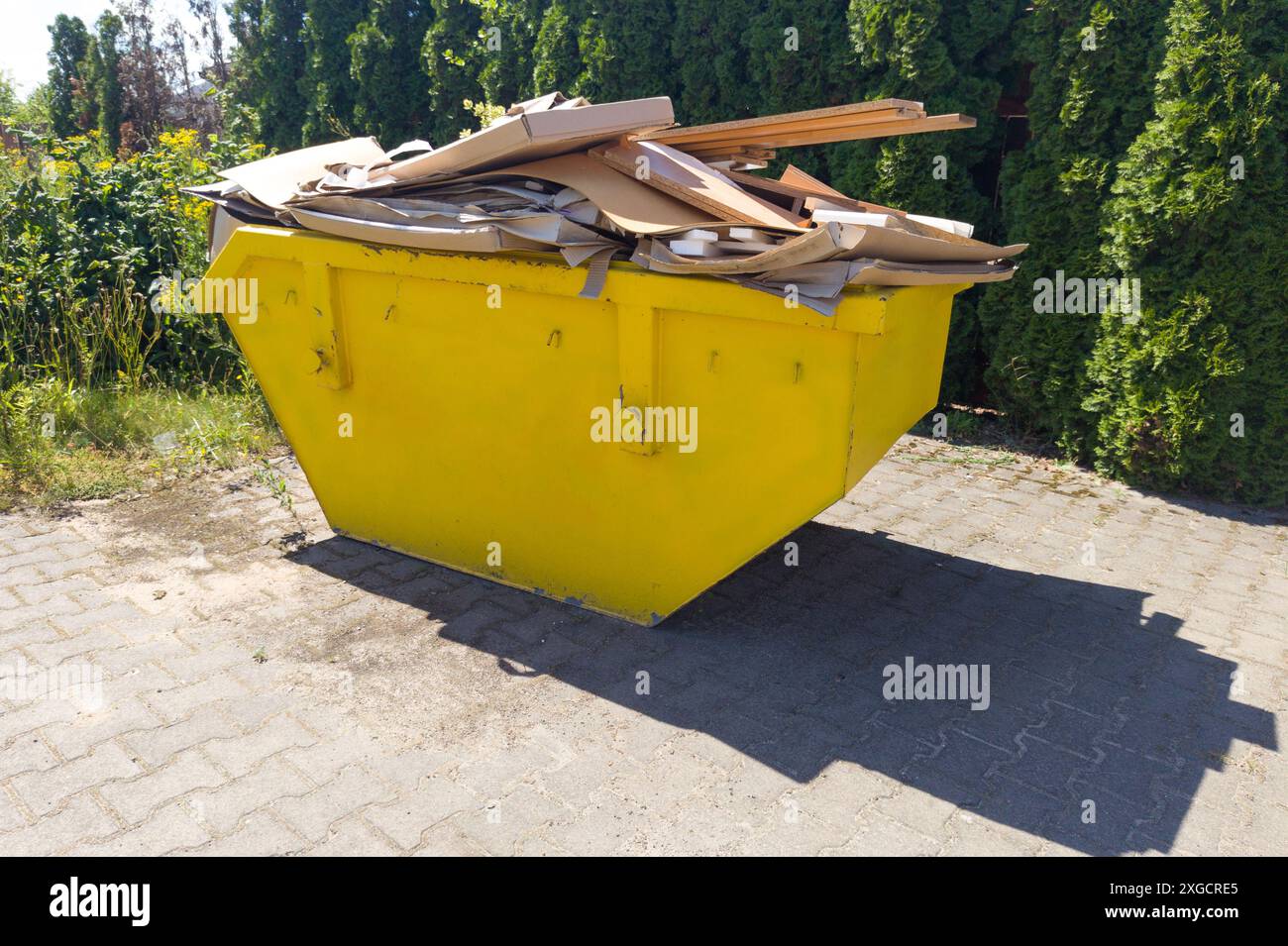 Yellow Dumpster Filled with Construction Debris Stock Photo - Alamy