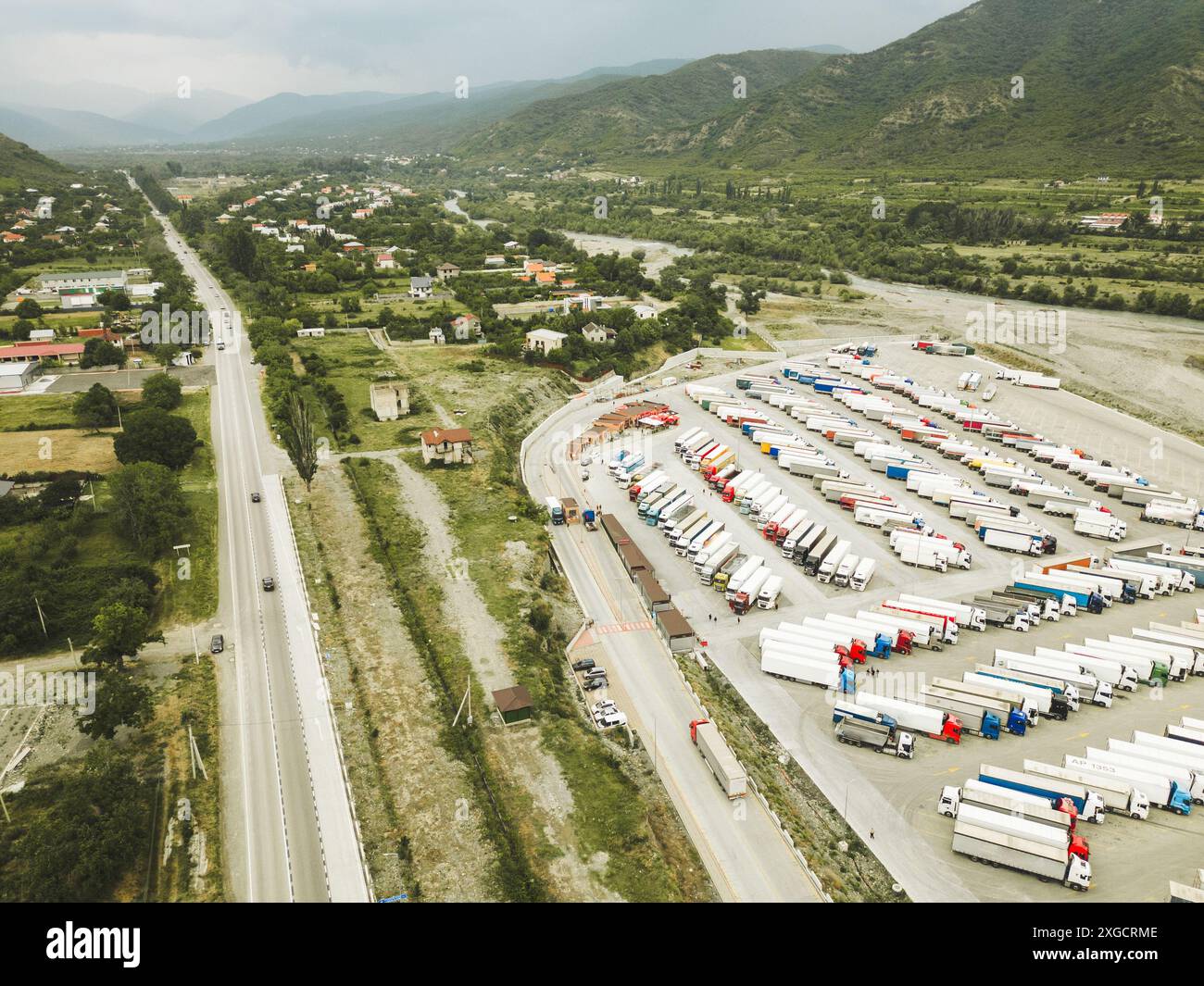 Aerial view lines of lorry trucks stand symmetrical in parking lot by ...
