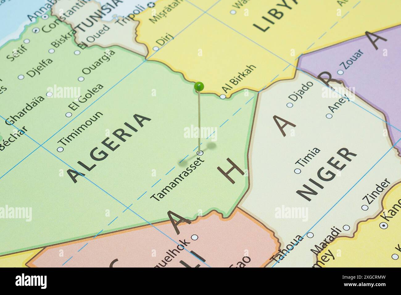 Close up to a Tamanrasset city with a green pin needle into Algeria ...