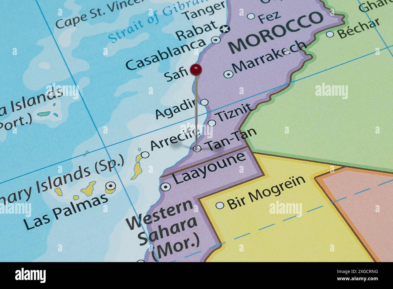 Close up to a Tan Tan city with a red pin needle into Morocco country ...