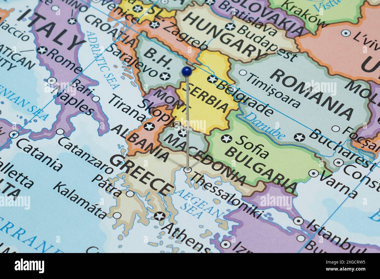Close up to a Thessaloniki city with a blue pin needle into Greece ...