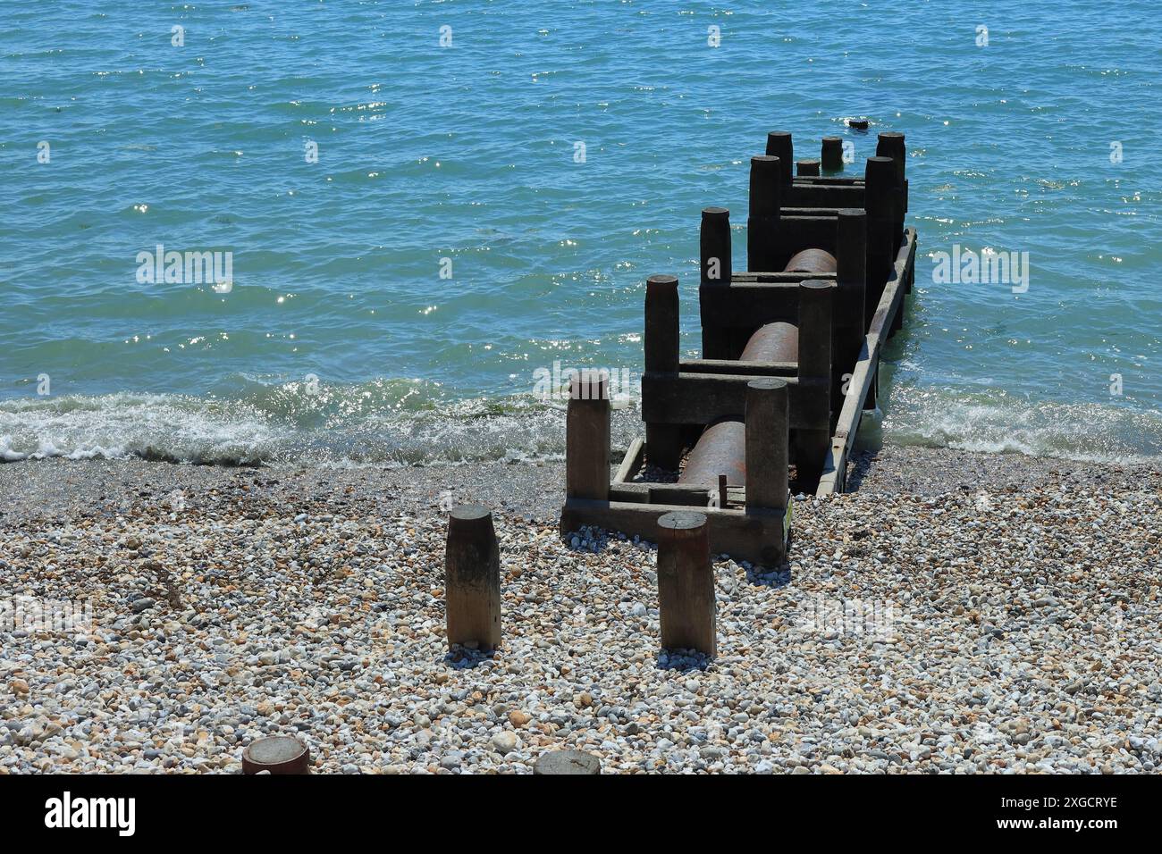 A sewerage outflow pipe on a shingle beach in southern England Stock ...