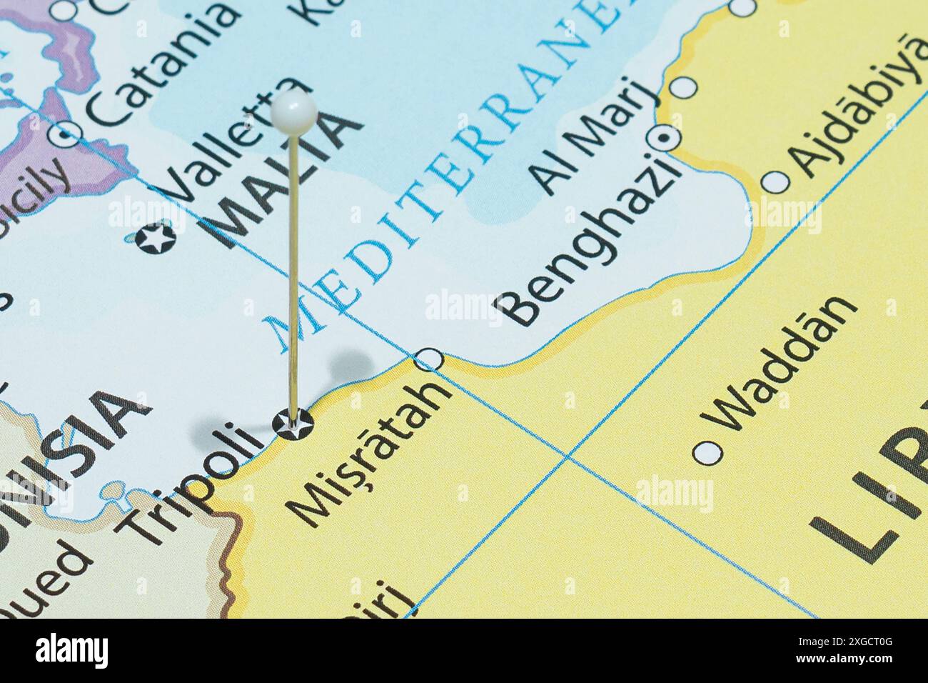 Close up to a Tripoli city with a white pin needle into Libya country ...
