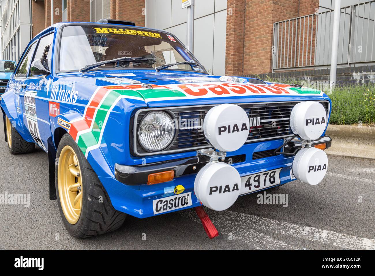 A Ford Escort rally car with full decal parked on the road in an urban ...
