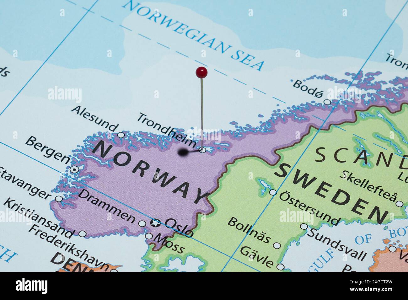 Close up to a Trondheim city with a red pin needle into Norway country ...