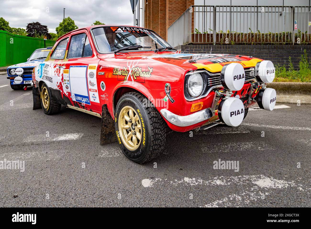 A Ford Escort rally car with full decal parked on the road in an urban ...