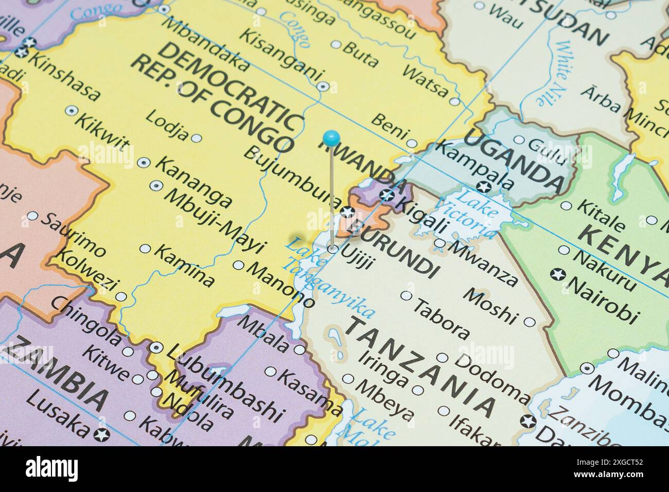 Close up to a Ujiji city with a light blue pin needle into Tanzania ...