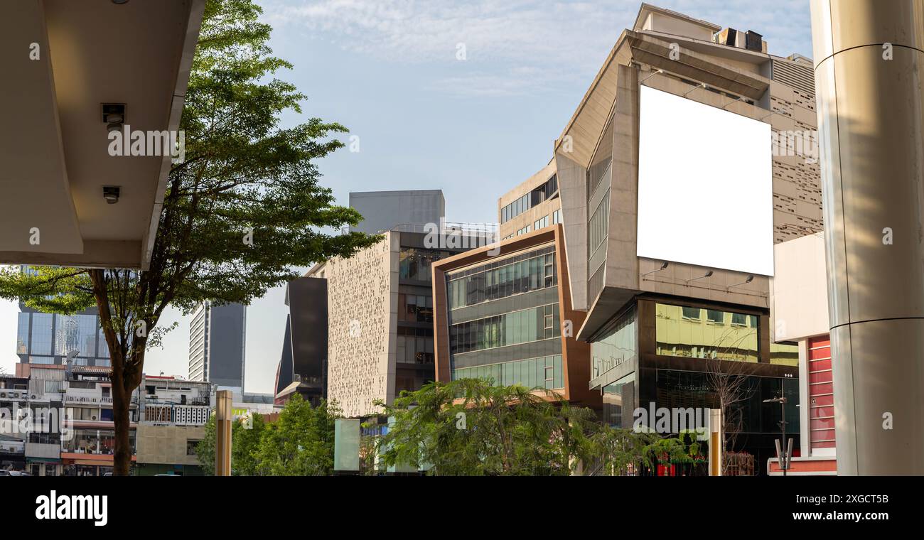 A blank billboard on the side of a building in a city. A large, empty ...