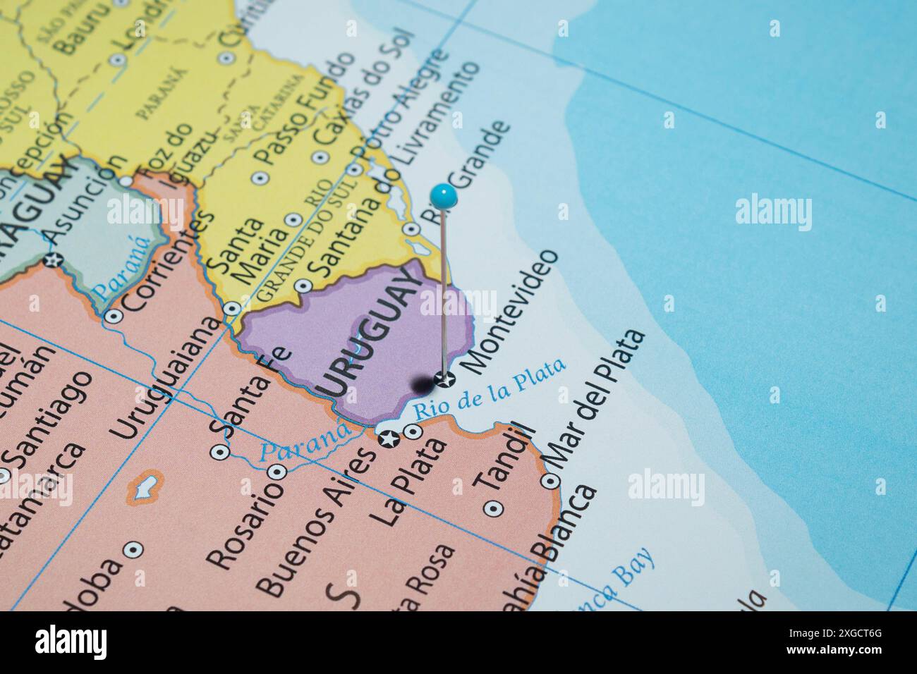 Close up to a Montevideo city with a light blue pin needle into Uruguay ...