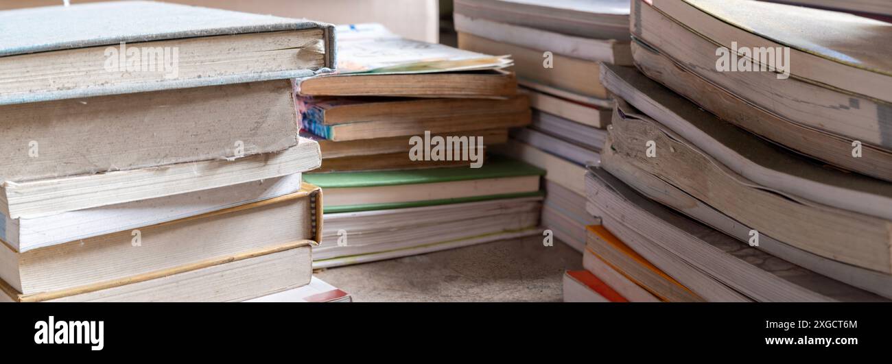 A stack of books in a variety of colors and sizes with different covers ...