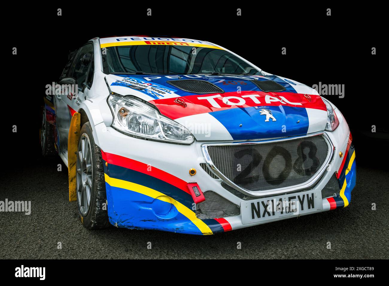 An atmospheric photograph of a parked Peugeot 208 rally car with full ...
