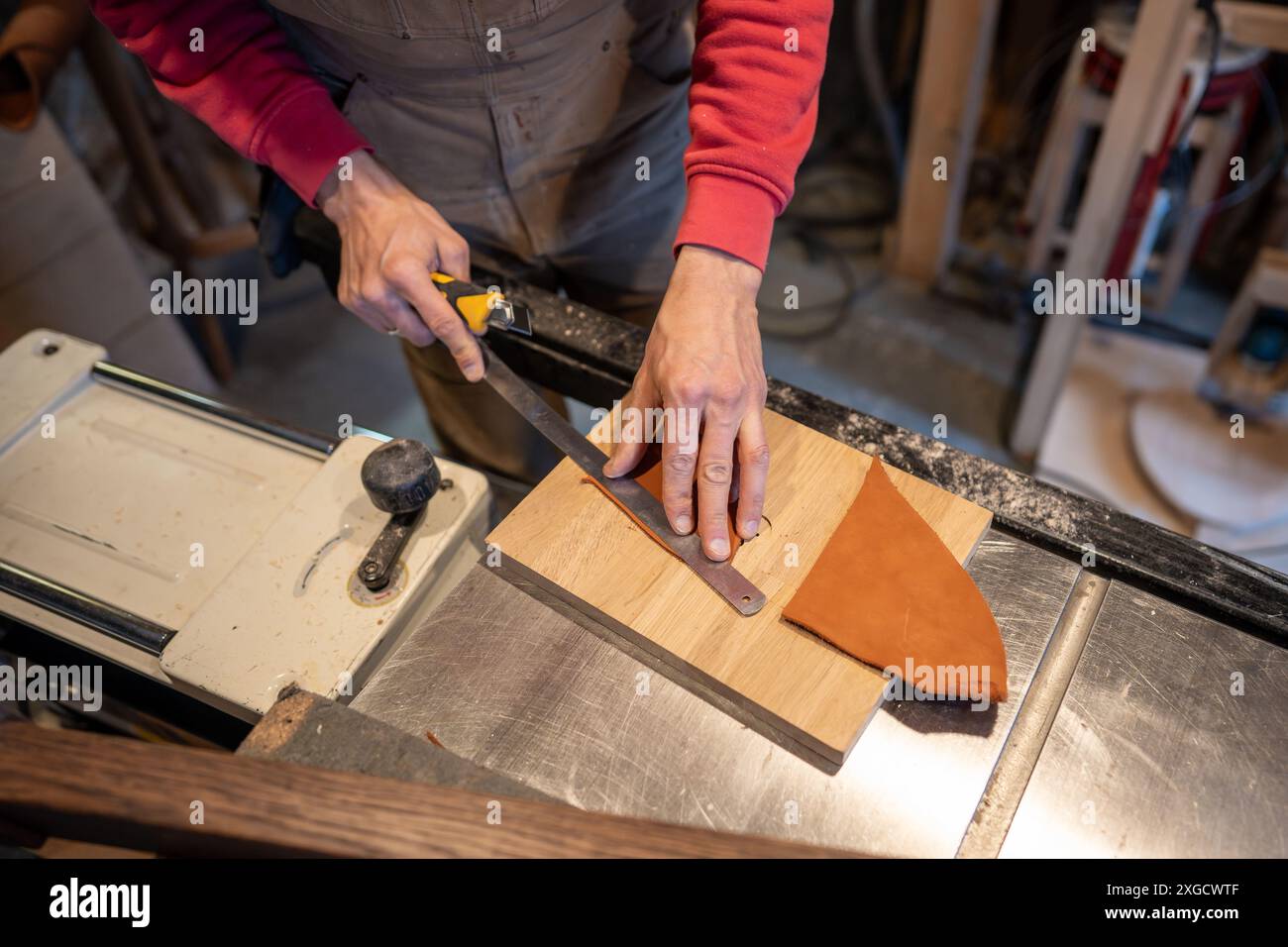 Male hands cutting leather skin. Master shoemaker cobbler professional ...