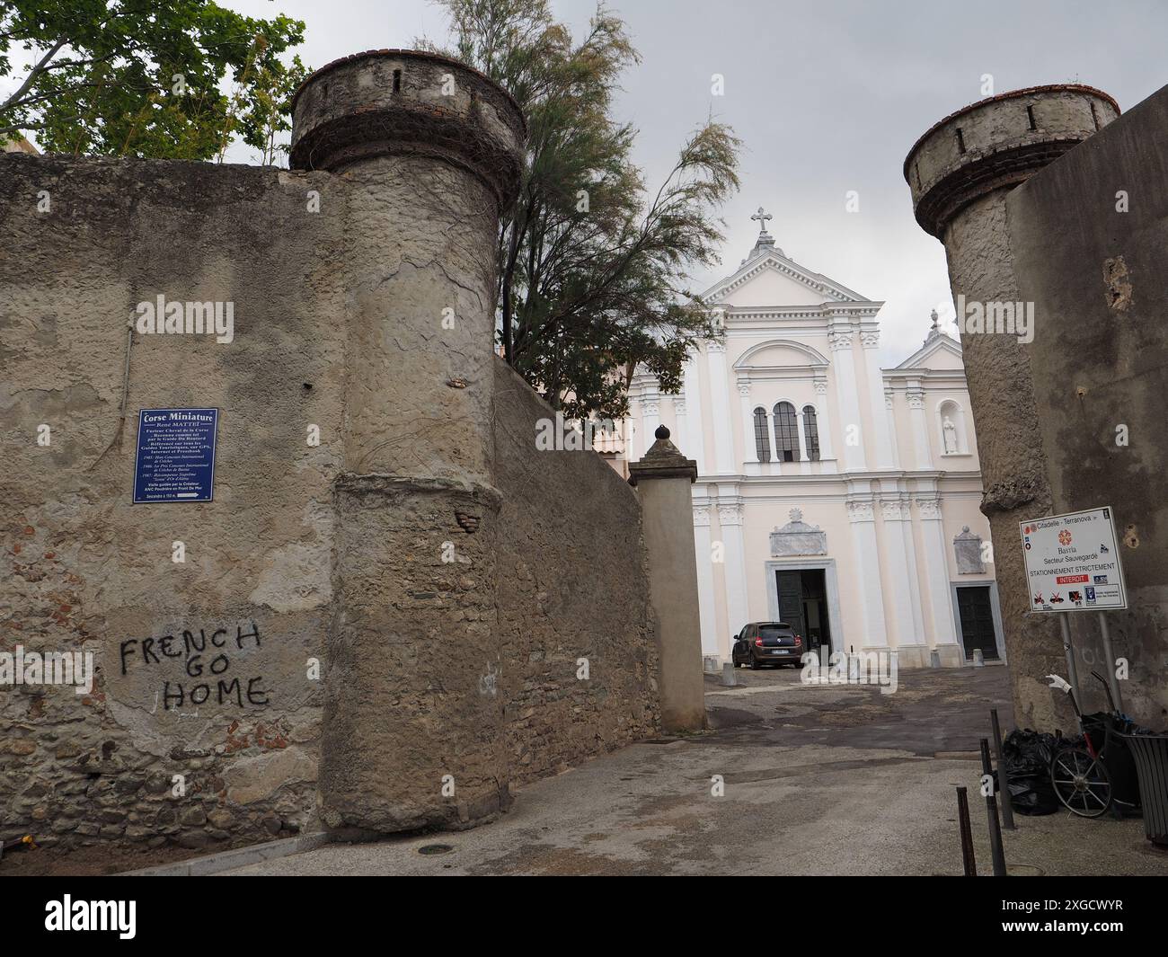 French go home graffiti on an old city wall in Bastia, Corsica, France ...