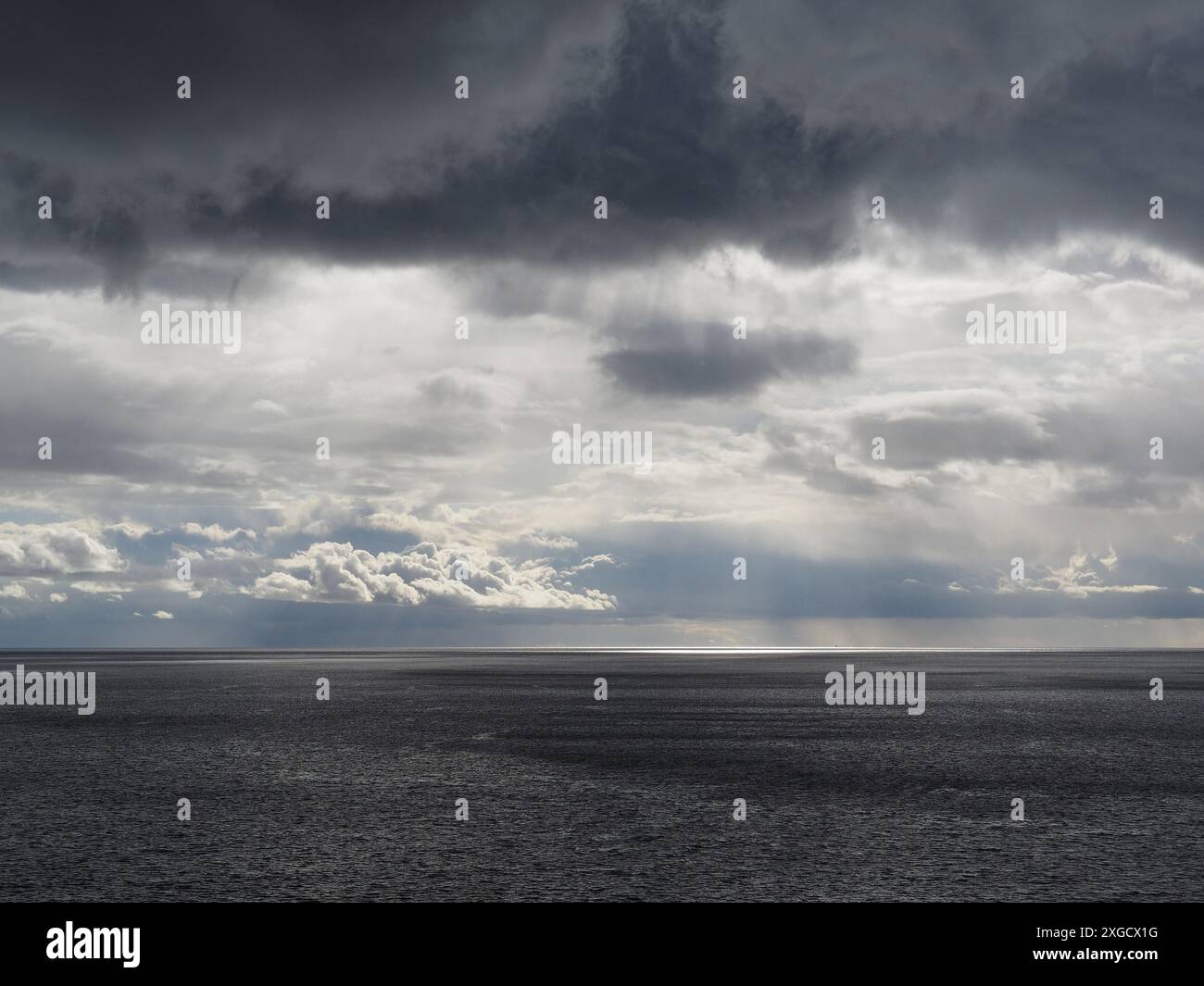 Seascape backlit mediterranean sea with clouds near Bastia, Corsica ...