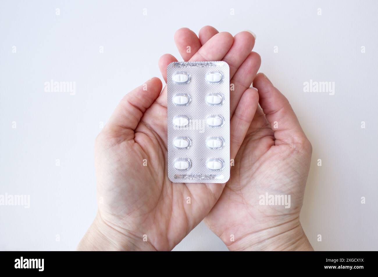 Human hands holding medical capsules packed in blister. Caucasian ...