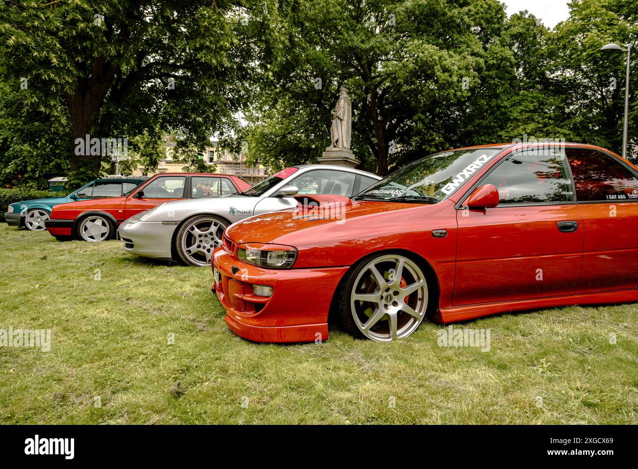 A row of sports and classic cars parked on a grassed area Stock Photo ...