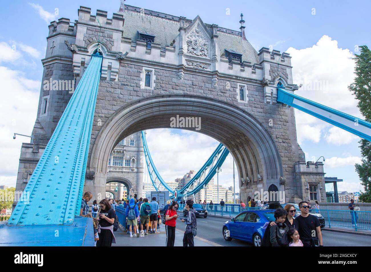 People walk on Tower Bridge in London as many tourists are expected to ...