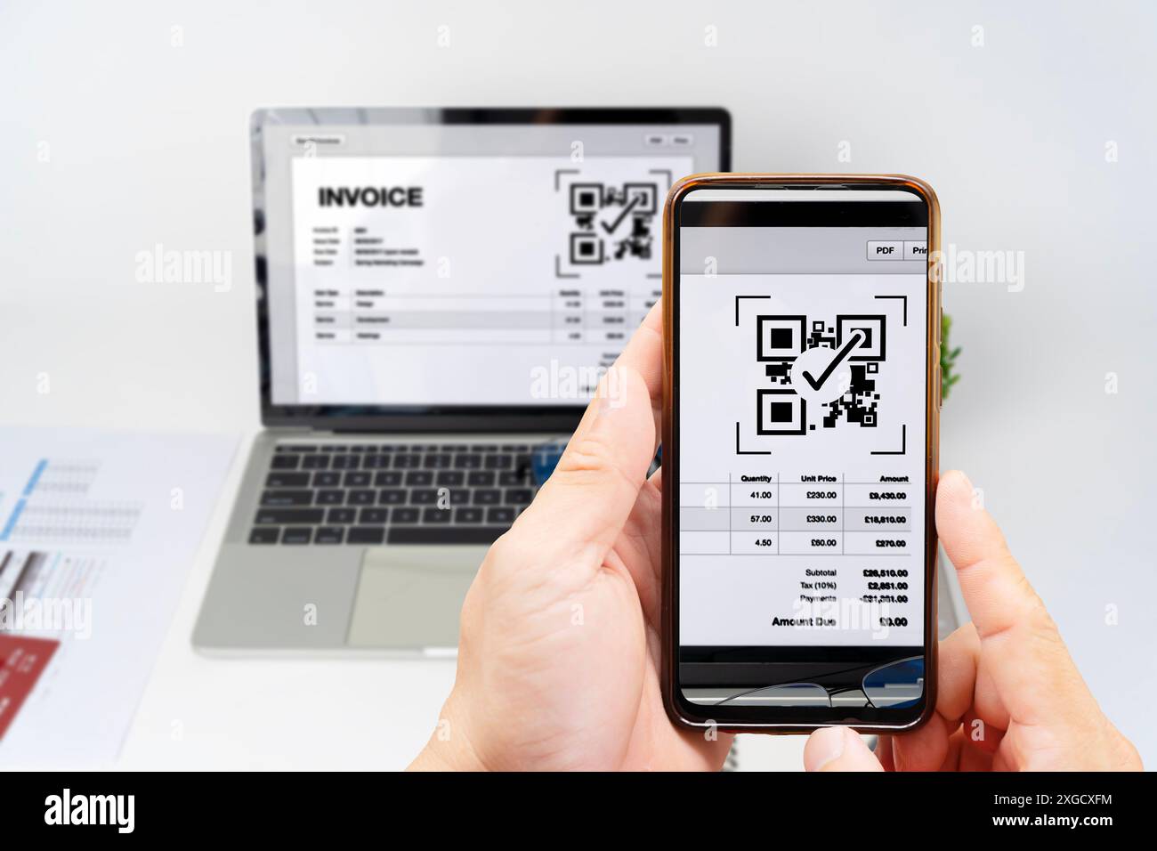Woman scanning QR code from invoice to make payment using fast secure payment system and ...