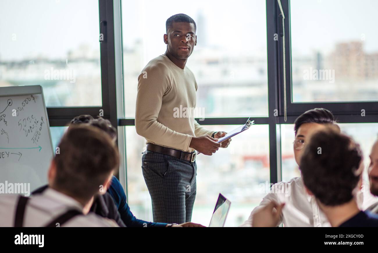 African american business couch provides to a multiracial group of ...