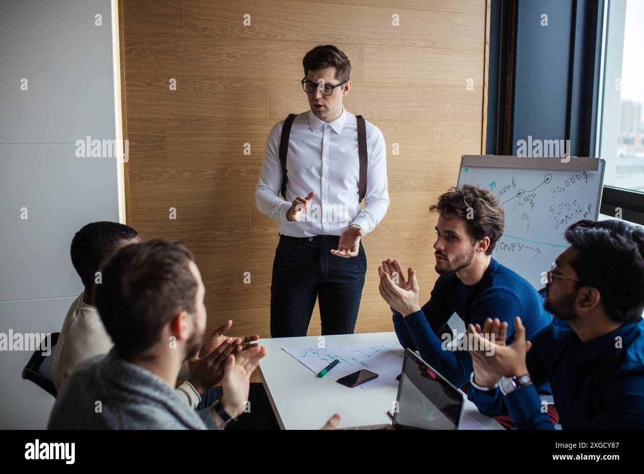 Caucasian businessman giving presentation using flip chart discussing ...