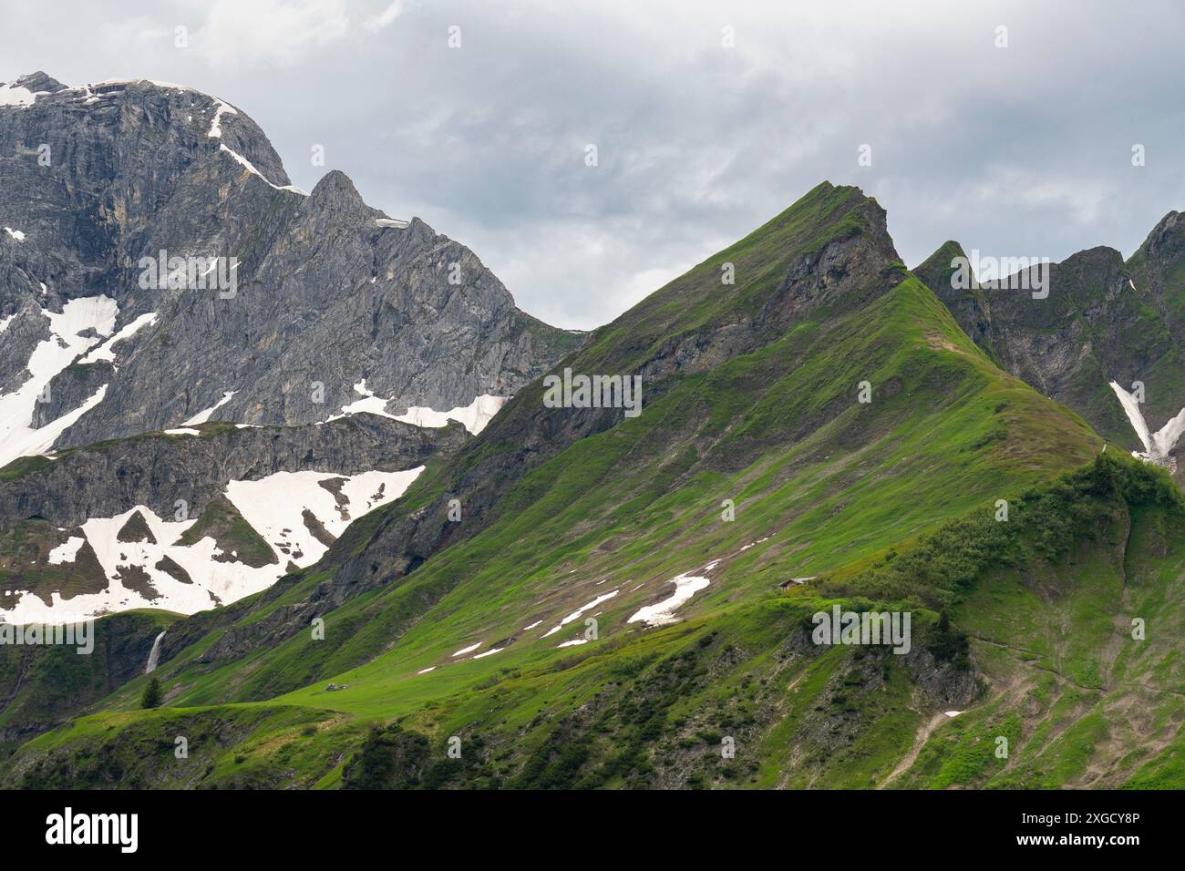 steep slope from Austrians alps, with green meadow just to the mountain ...