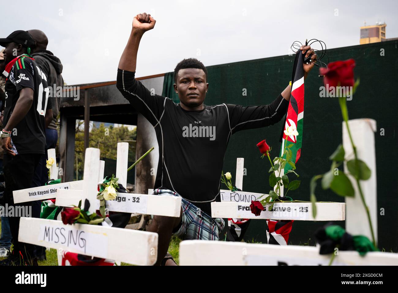 A man raises his fist in solidarity with Kenyans fighting for justice ...