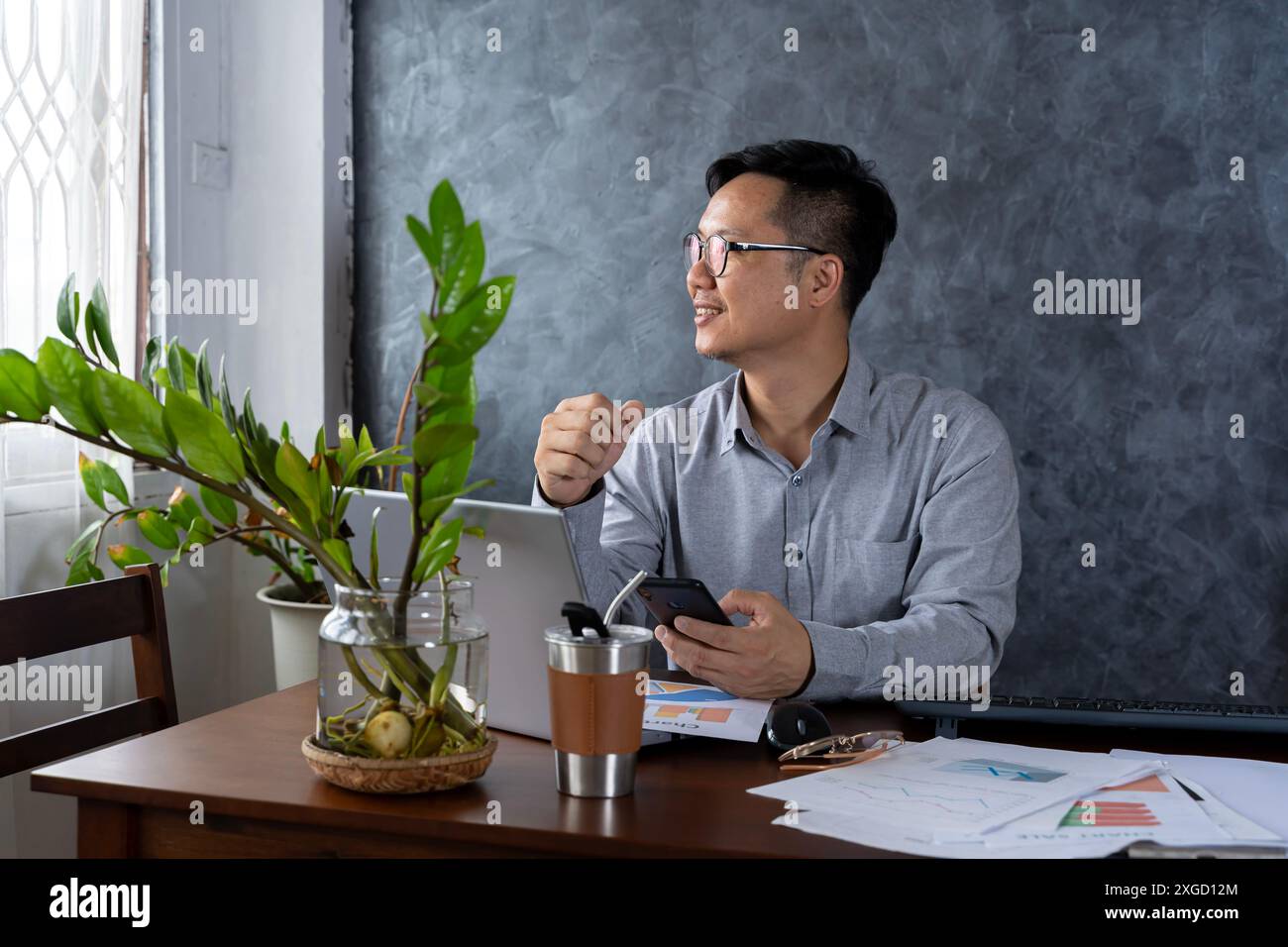 Successful asian man inside office looking out the window, boss in ...