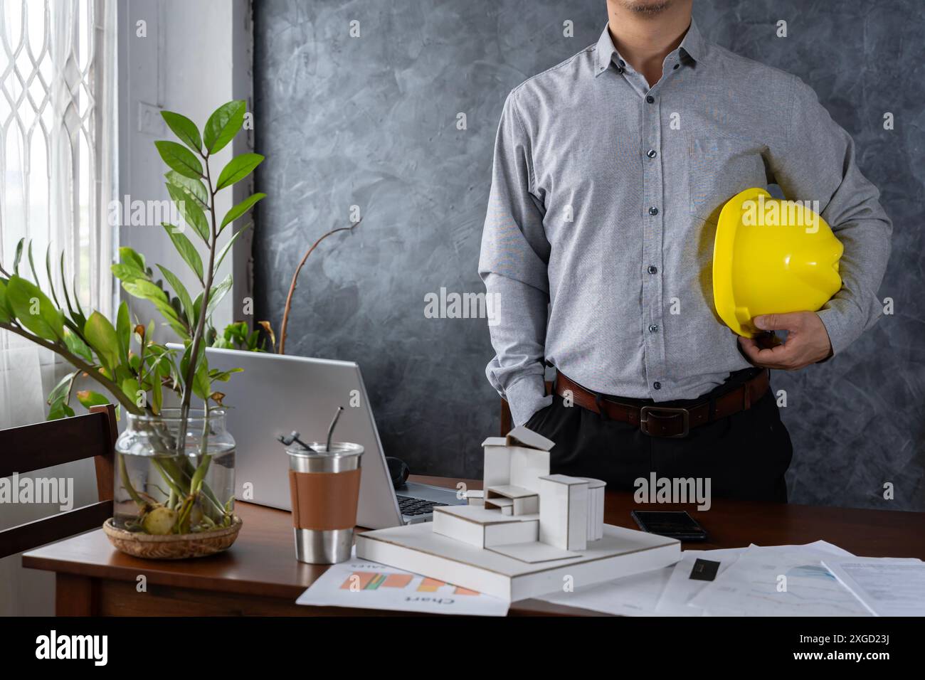 Engineer holding helmet checking accuracy of building structural ...