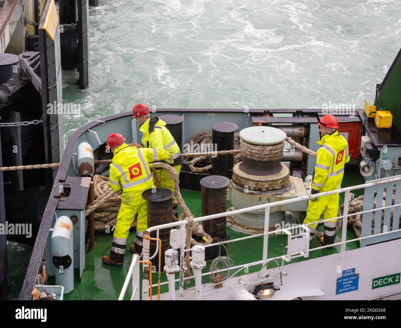 Merchant seamen on a ferry docking at Lochmaddy on North Uist, Outer ...