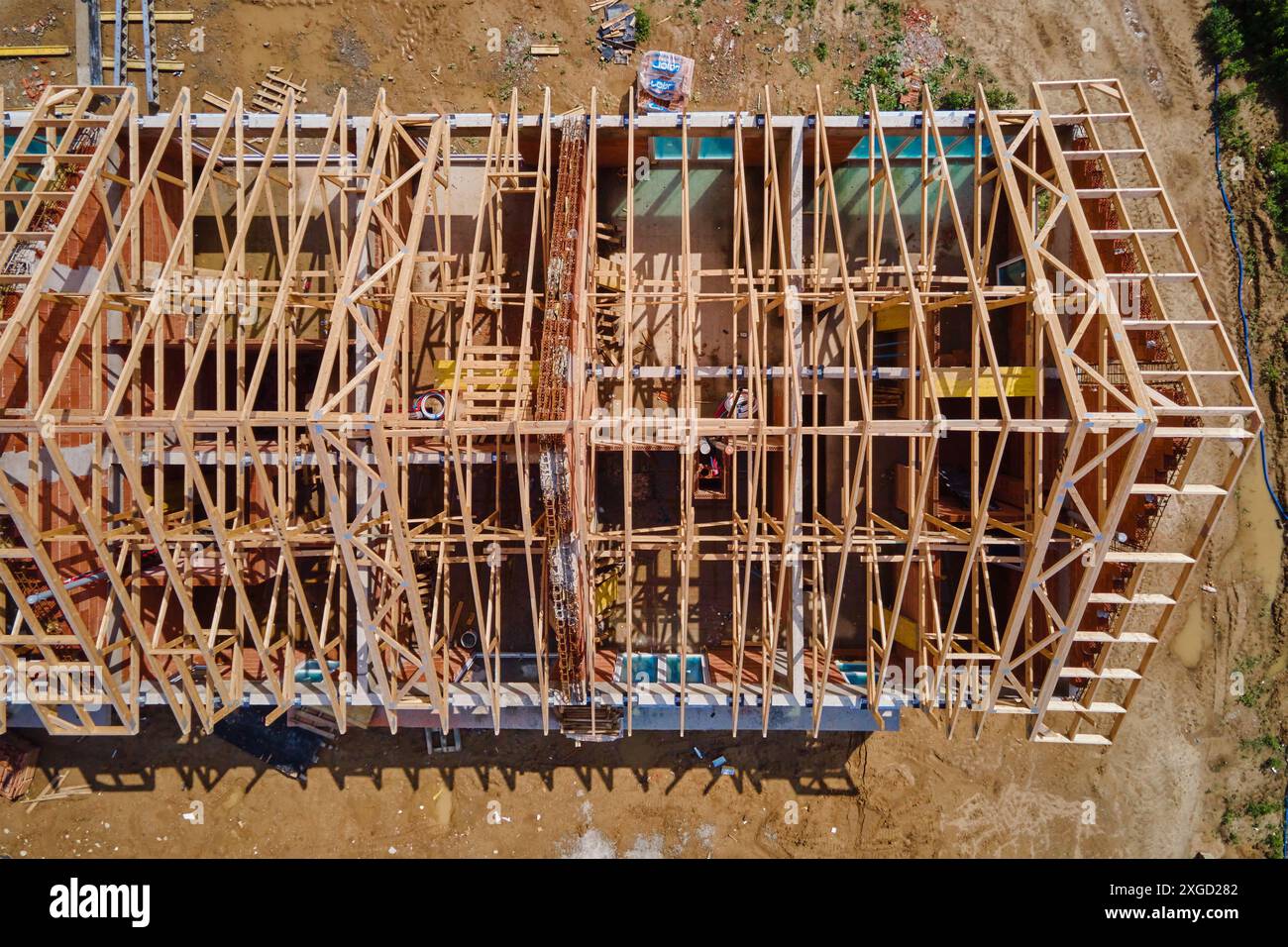 New house under construction, wooden truss system forming roof. Process ...