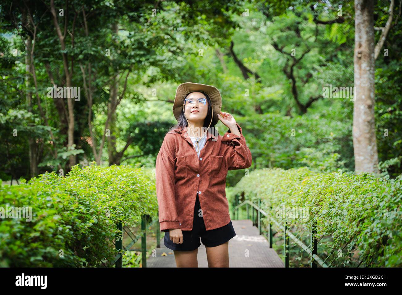 Forest in Thailand, beautiful smiling young woman wearing a jacket and ...