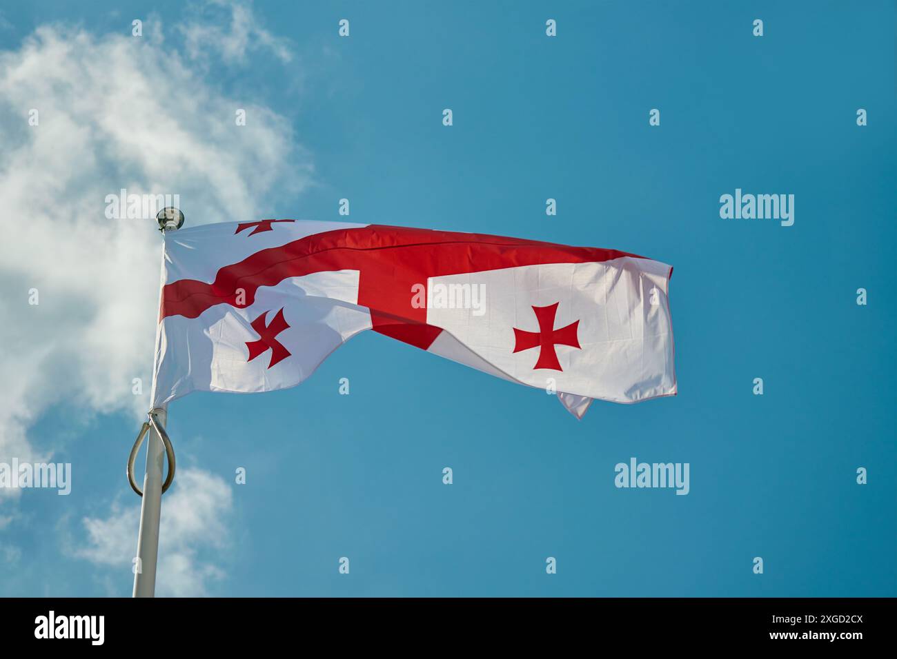 National flag of Georgia waves against bright blue sky Stock Photo - Alamy