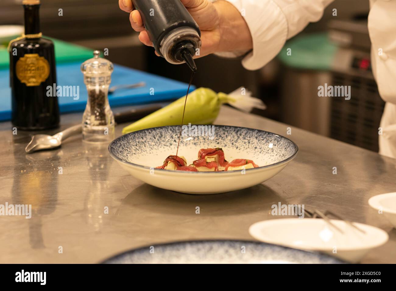 Hand garnishing dish hi-res stock photography and images - Alamy