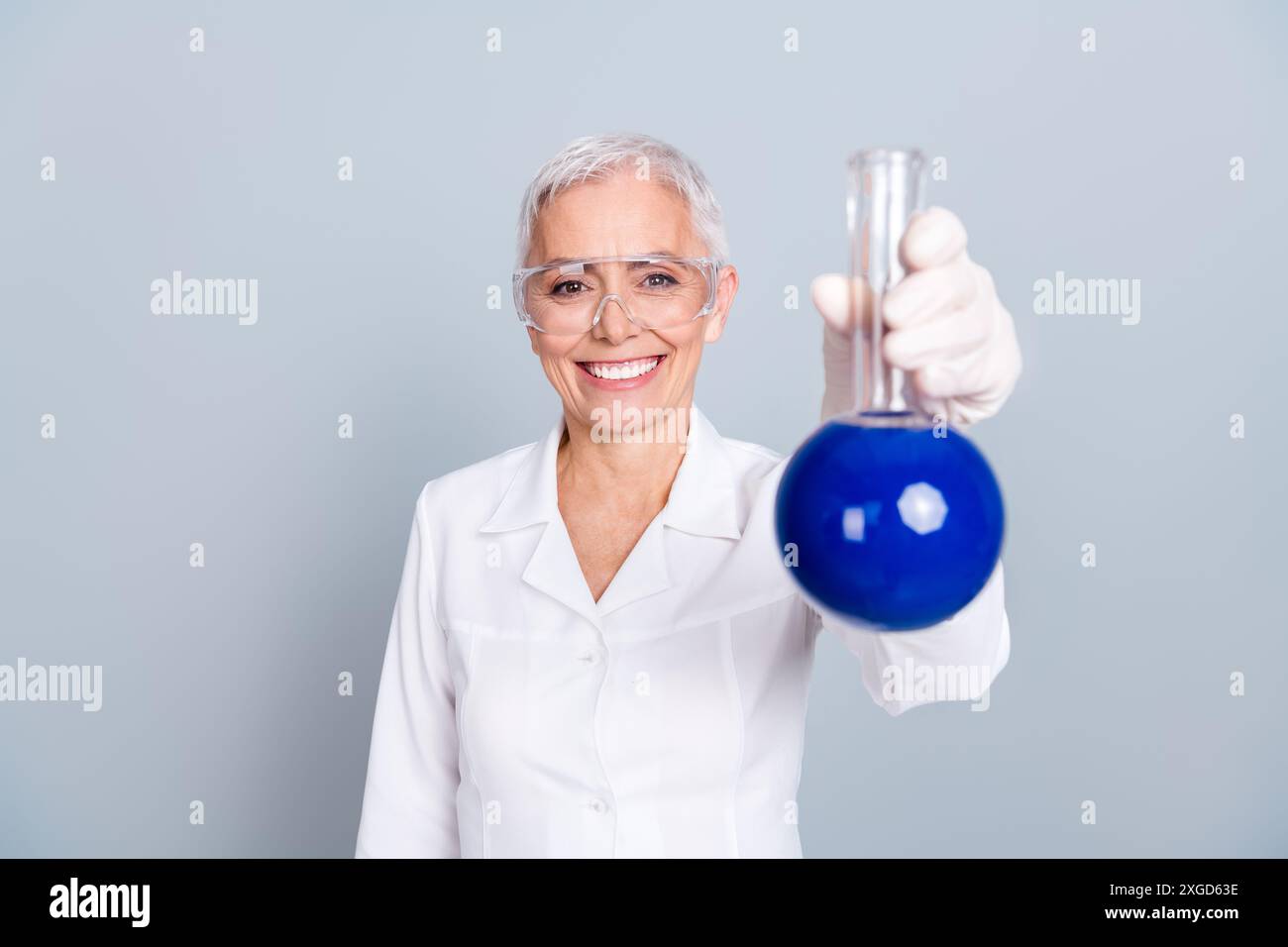 Photo of happy scientist woman invent fluid experiment showing isolated ...