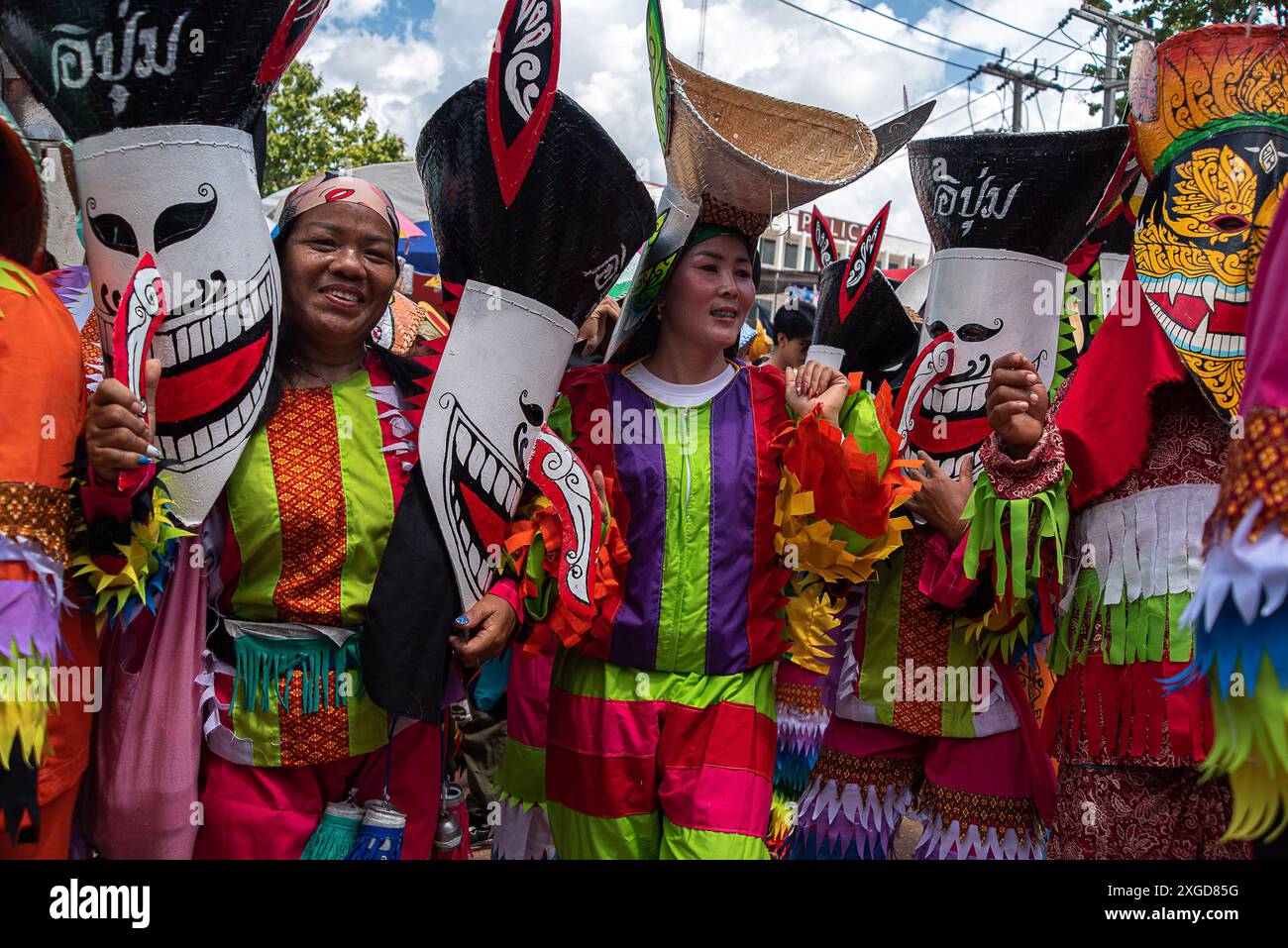 Participants wearing ghost masks and dressed in costumes take part ...