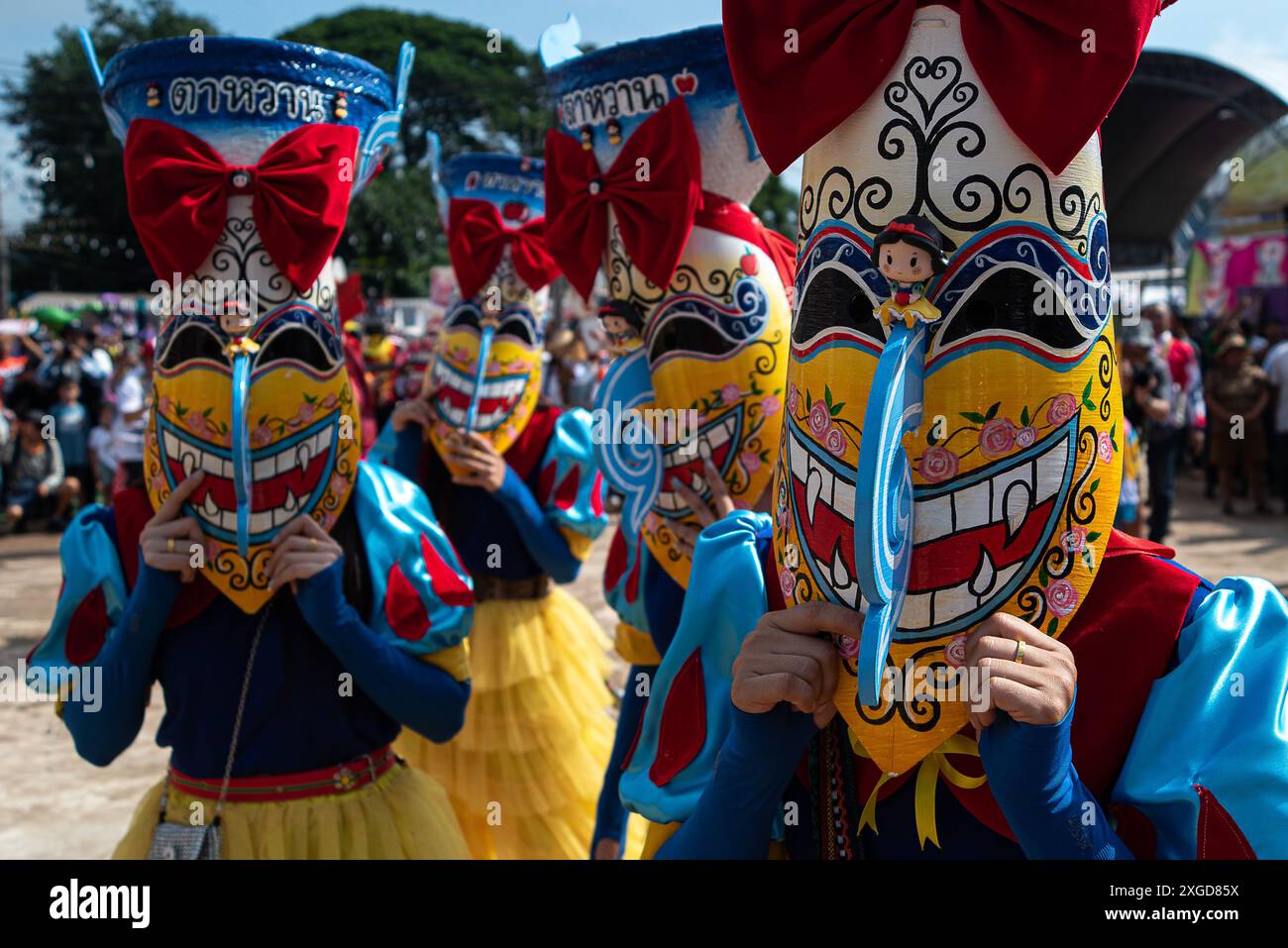 Participants wearing ghost masks and dressed in costumes take part ...