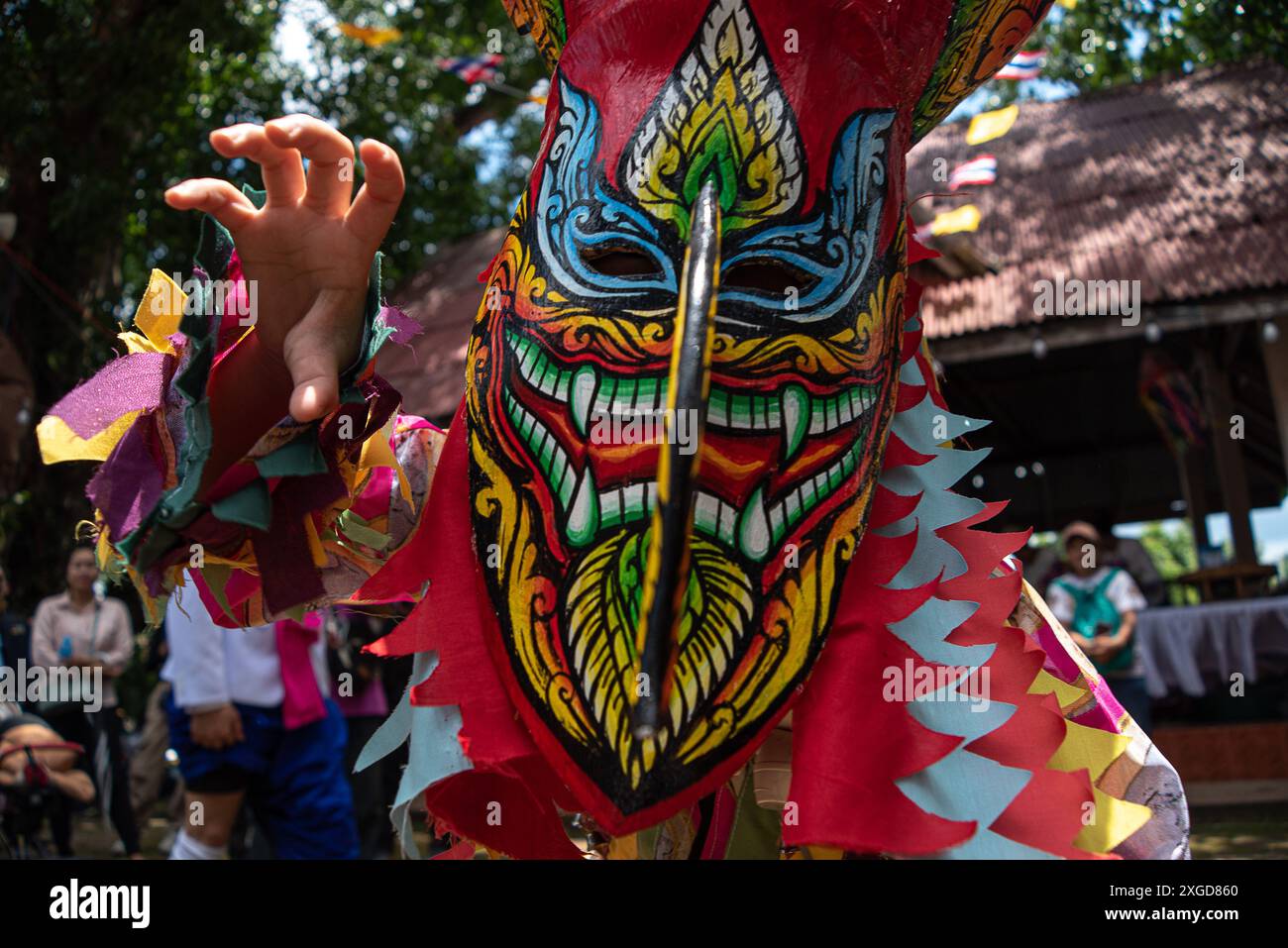 A participant wearing a ghost mask and dressed in costume takes part ...