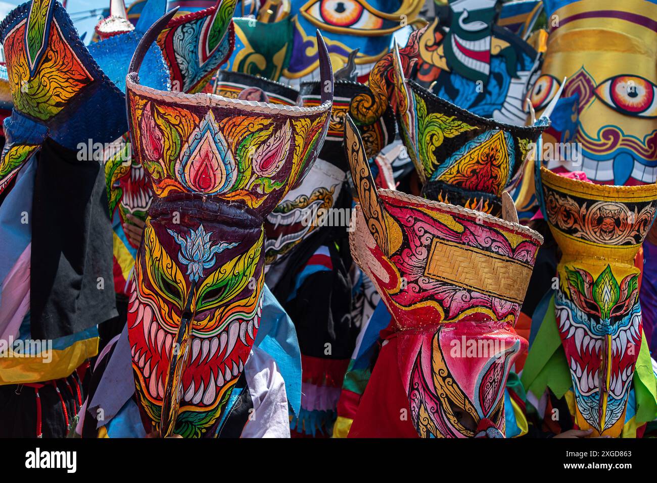 Participants wearing ghost masks and dressed in costumes take part ...