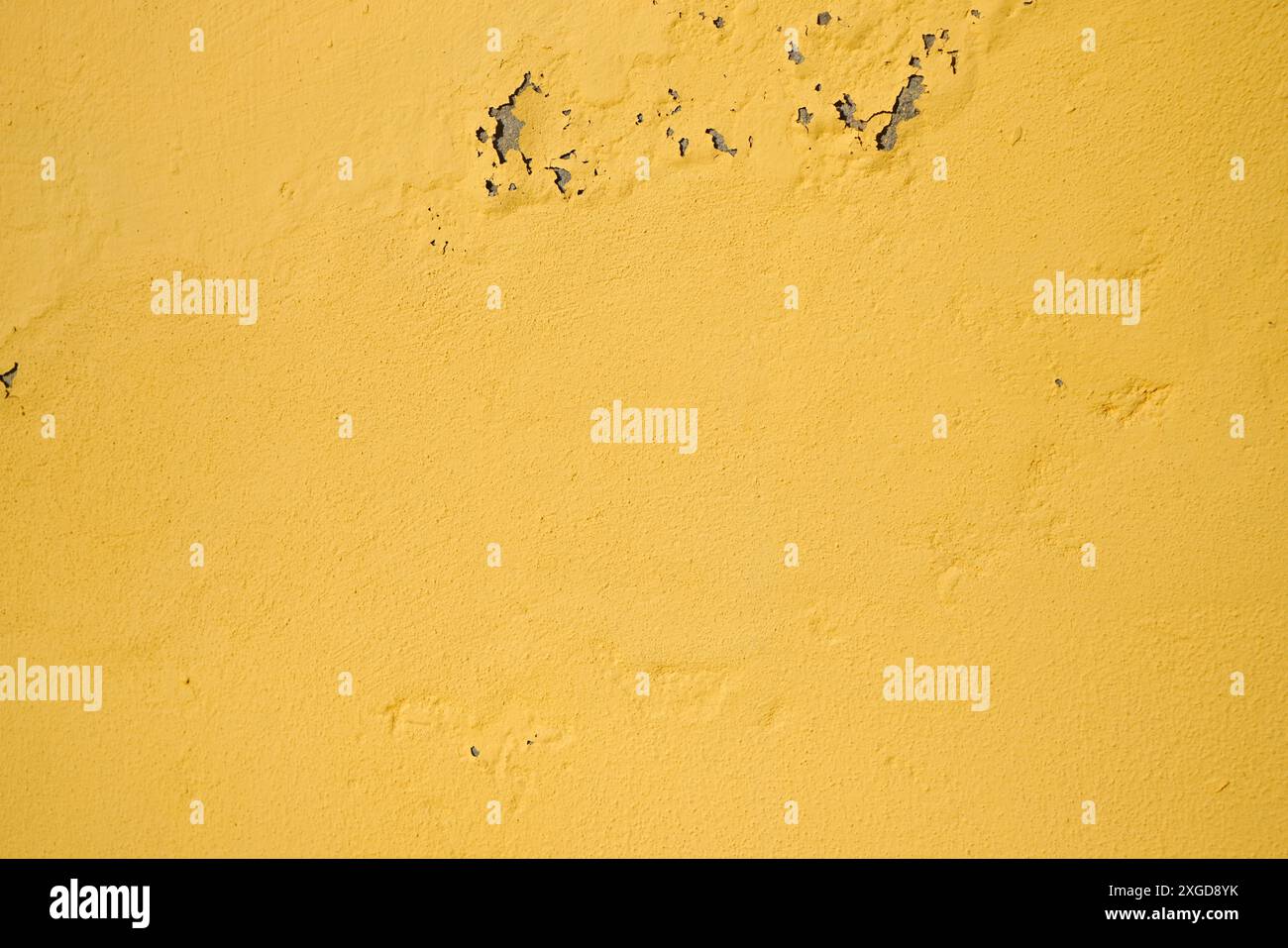 Yellow peeling paint on the old rough concrete wall,weathered rough ...